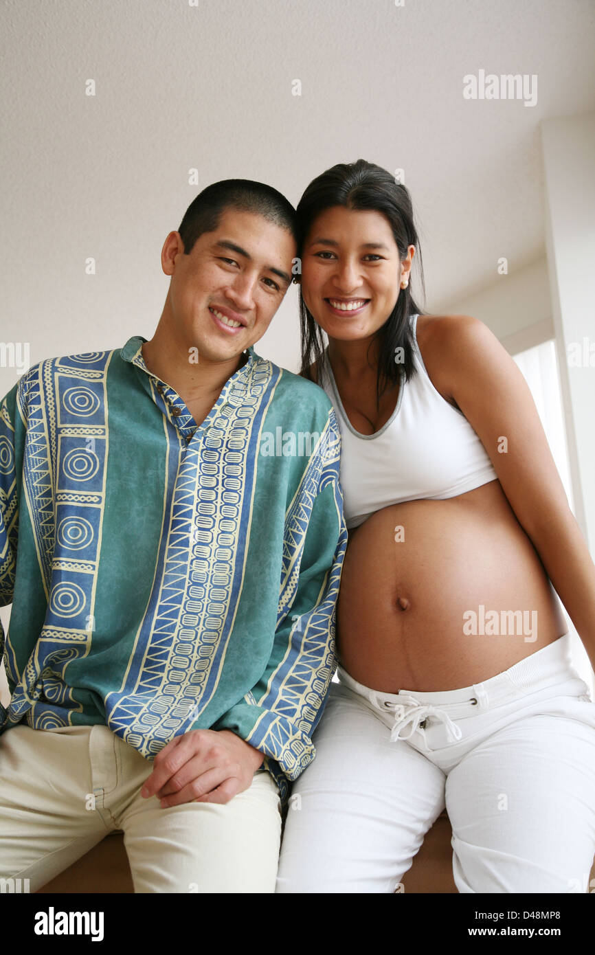 Pregnant couple smiling, posing Stock Photo - Alamy