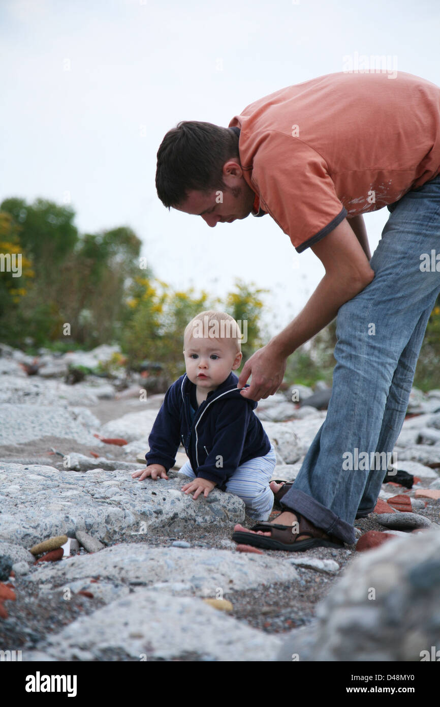 Father helping son Stock Photo - Alamy
