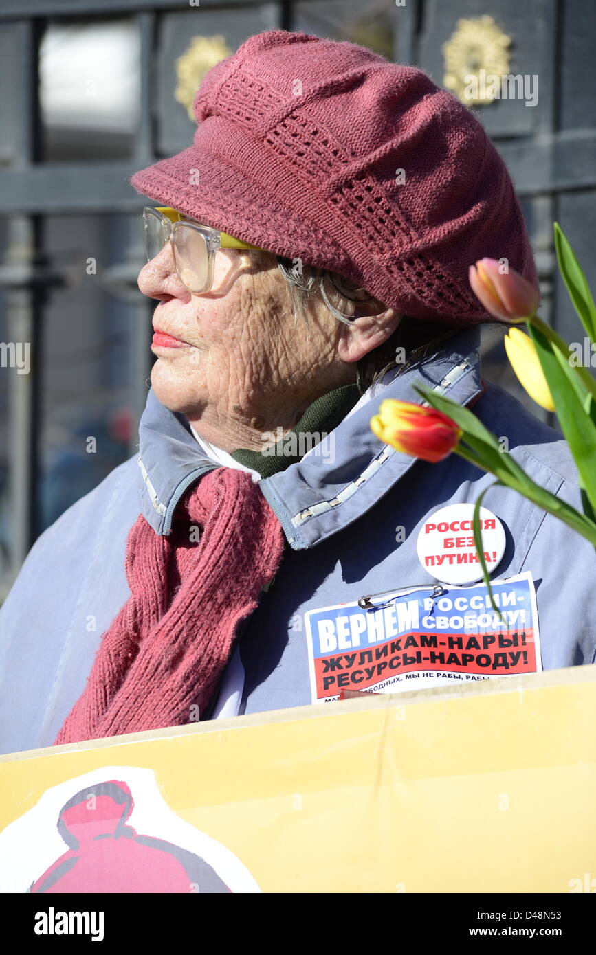 Elder russian woman activist with flowers and signs reads 'Russia ...