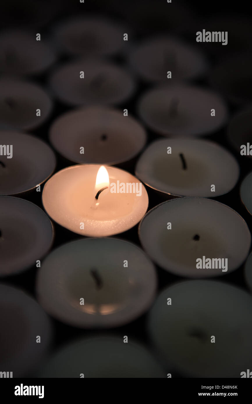 Single candle lighting in the dark Stock Photo - Alamy