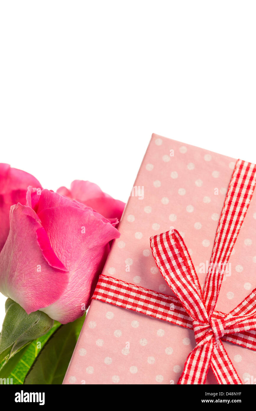 Pink roses leaning on pink wrapped present Stock Photo - Alamy