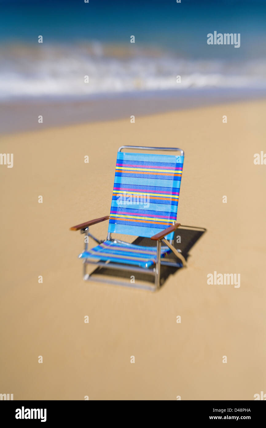 Brightly Colored Beach Chair On The Sand Near The Ocean Stock Photo - Alamy