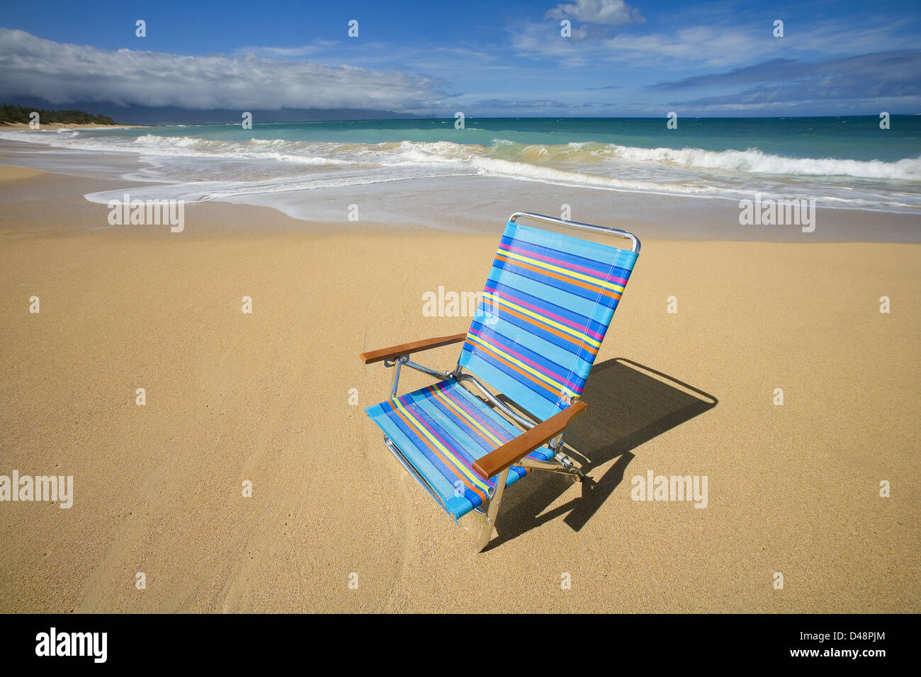 Brightly Colored Beach Chair On The Sand Near The Ocean Stock Photo - Alamy