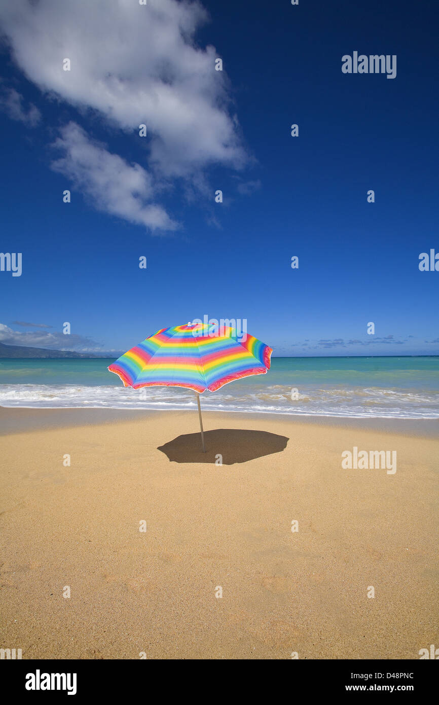 Brightly Colored Beach Umbrella On The Sand Near The Ocean Stock Photo ...