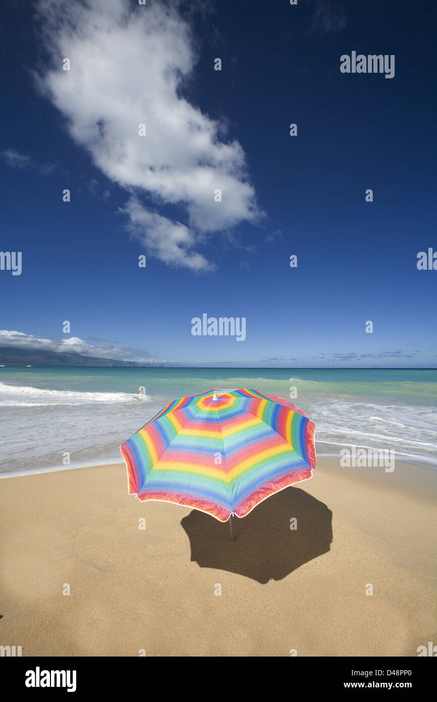 Brightly Colored Beach Umbrella On The Sand Near The Ocean Stock Photo ...