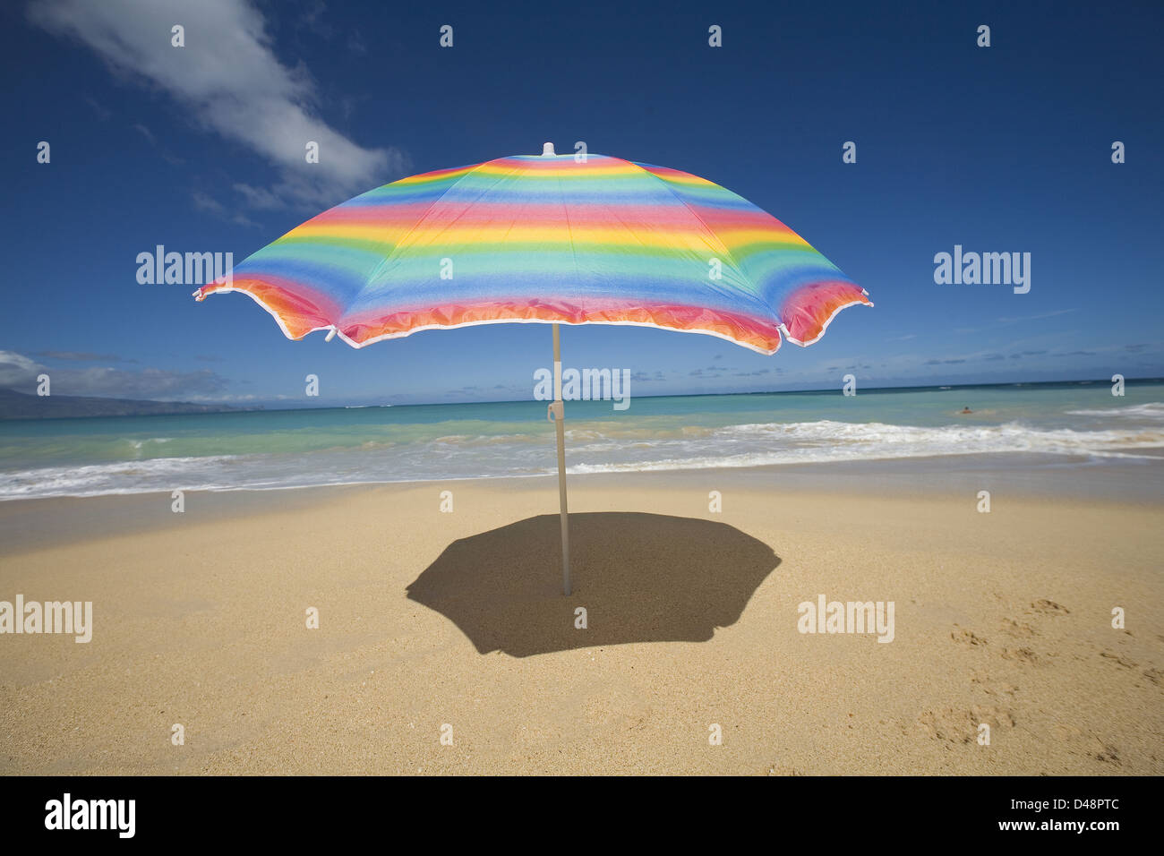 Brightly Colored Beach Umbrella On The Sand Near The Ocean Stock Photo ...