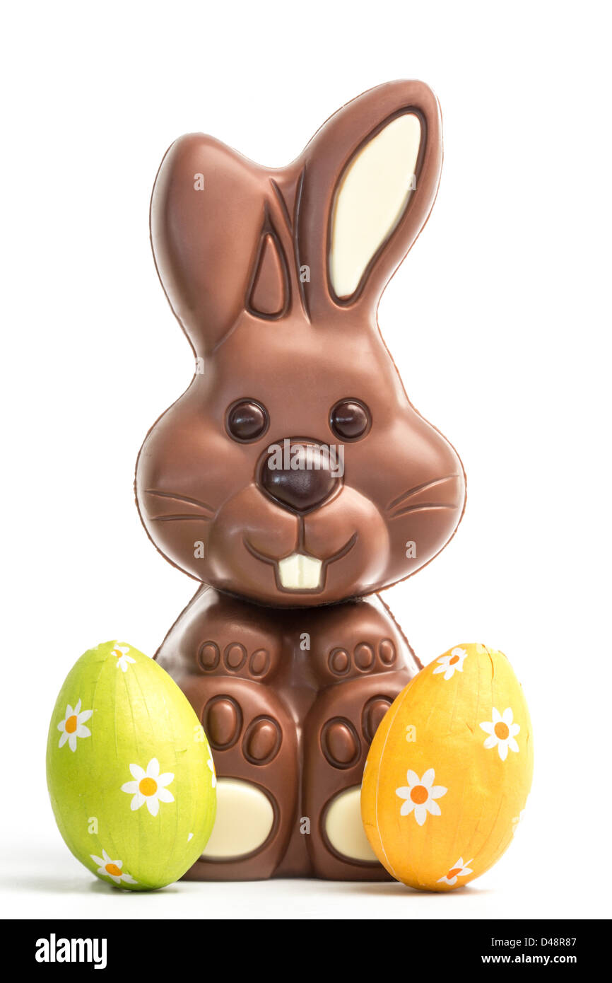 Cute chocolate bunny with two easter eggs Stock Photo - Alamy