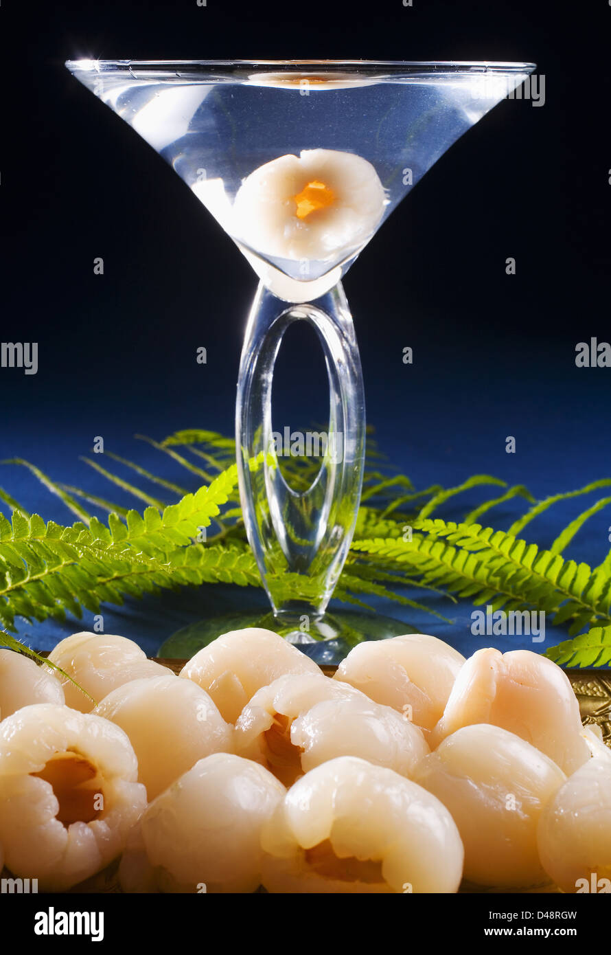A Lychee Martini On A Blue Background With Lychee In Foreground Stock ...
