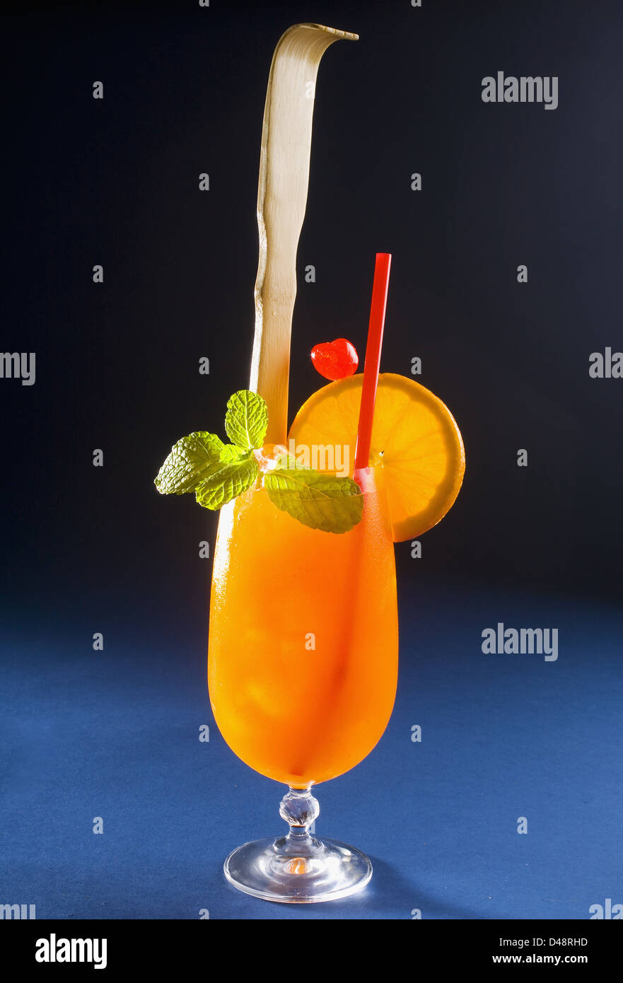 A Tropical Itch Cocktail Garnished With Fruit And A Backscratcher Stock ...