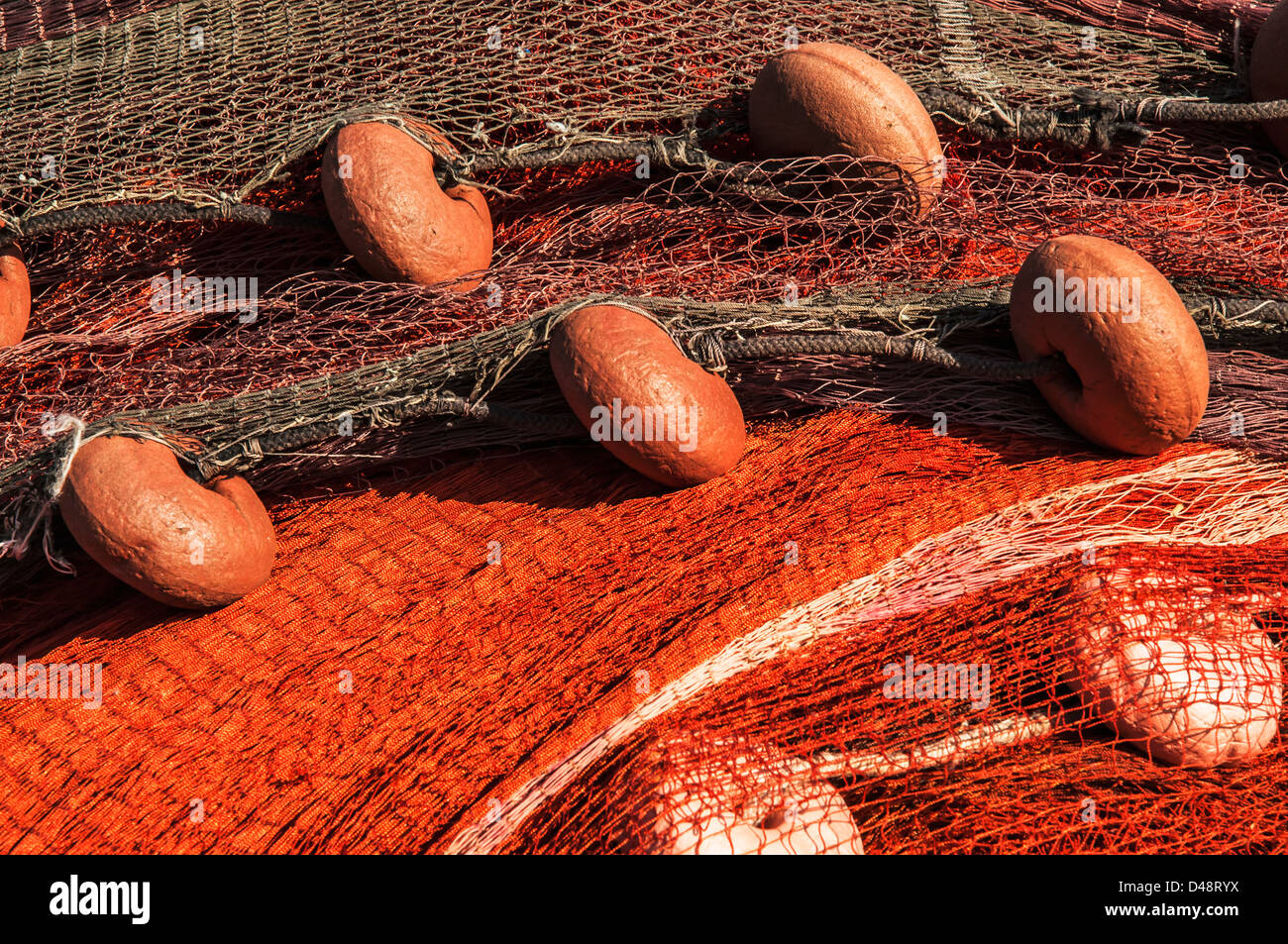 colored fishing net in a small harbor Stock Photo - Alamy
