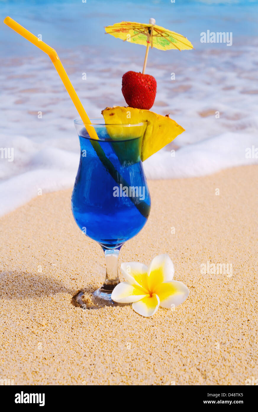 A Blue Hawaii Tropical Cocktail On The Beach, Wave Washing On The Sand ...