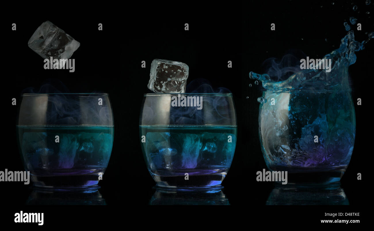 Serial arrangement of ice falling into glass of blue liquid Stock Photo ...