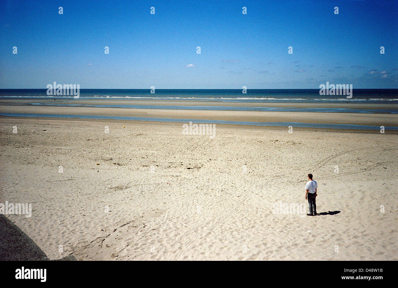 Man standing on beach, Calais, France Stock Photo - Alamy