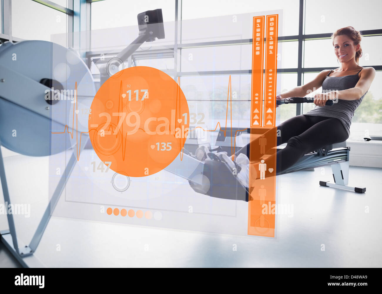 Young girl on rowing machine with futuristic interface showing calories ...