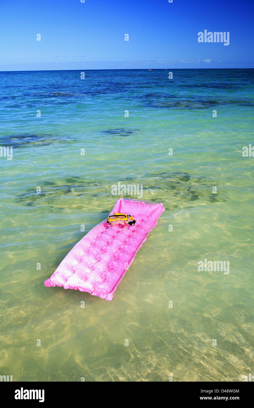 Snorkel And Mask Rest On Pink Inflated Raft Afloat On Clear Ocean Water ...