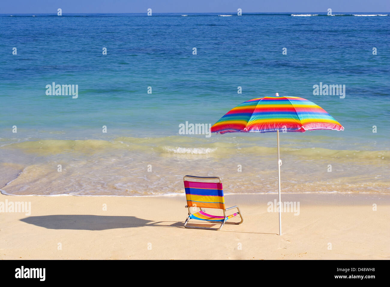 Colorful Beach Chair And Umbrella On The Shoreline Of A Tropical Beach ...