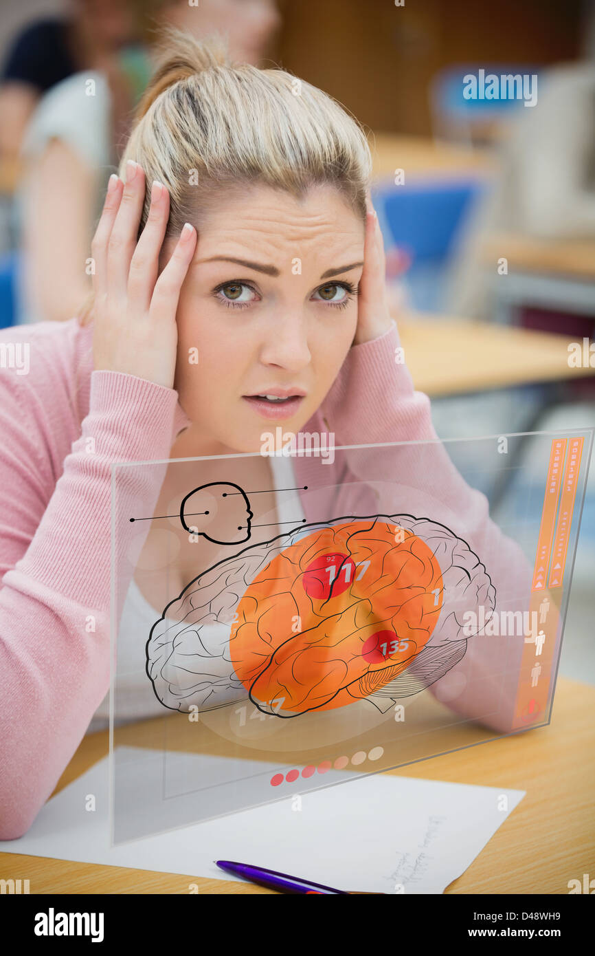 Blonde woman thinking hard while studying on futuristic interface Stock ...