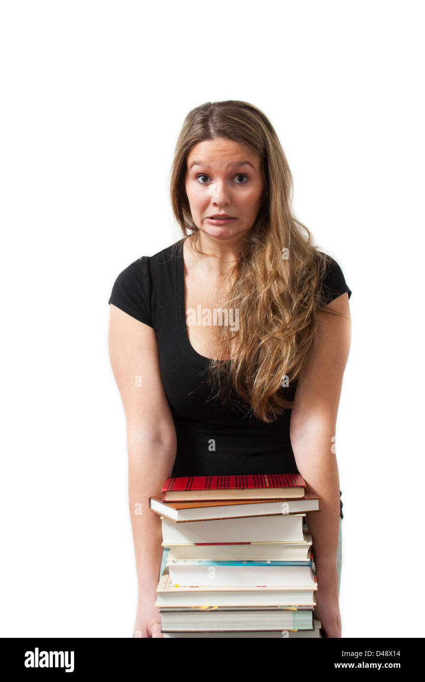 A female college student with a heavy stack of books isolated on white ...