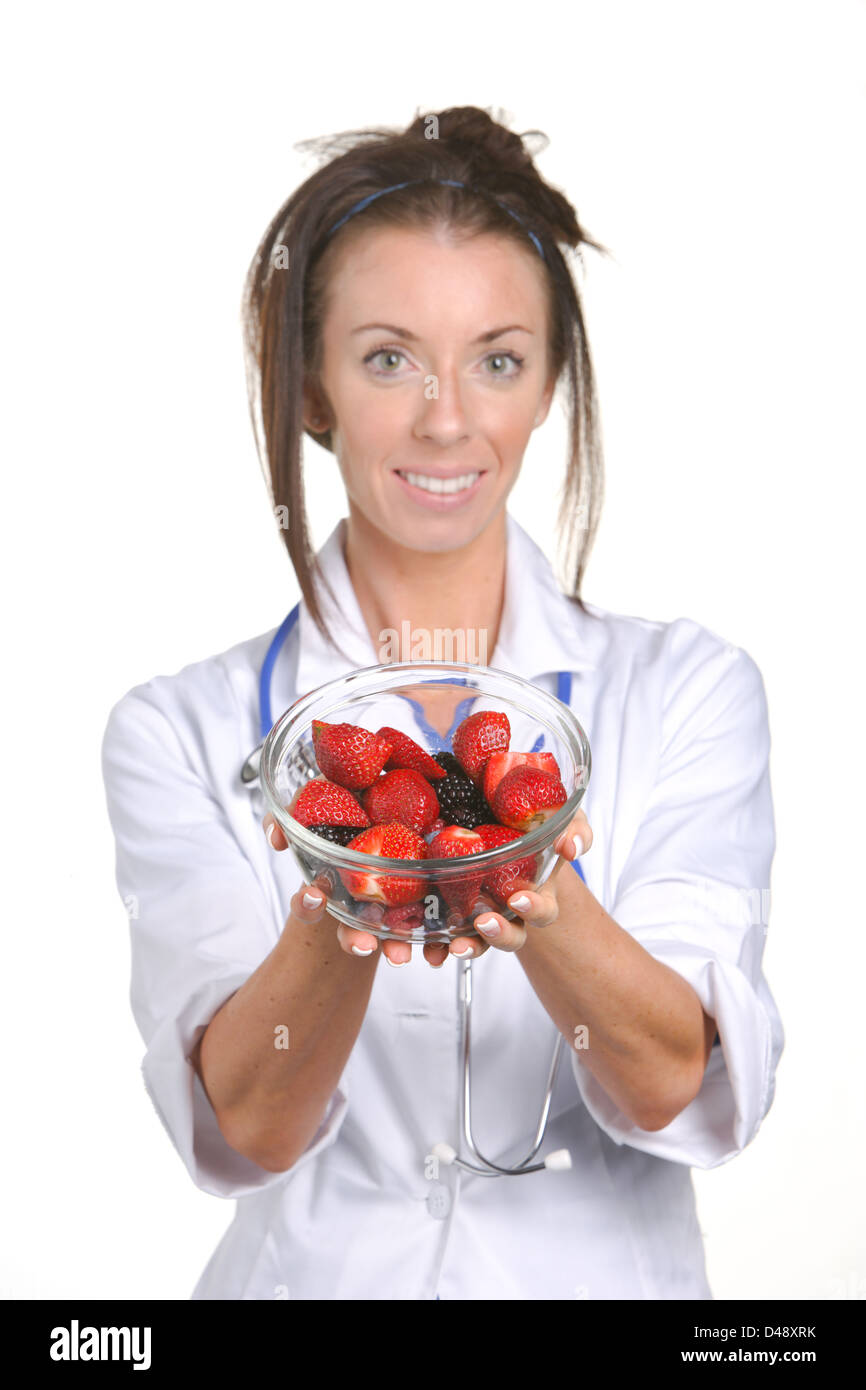 Woman doctor holding fresh fruit focus on fruit Stock Photo - Alamy