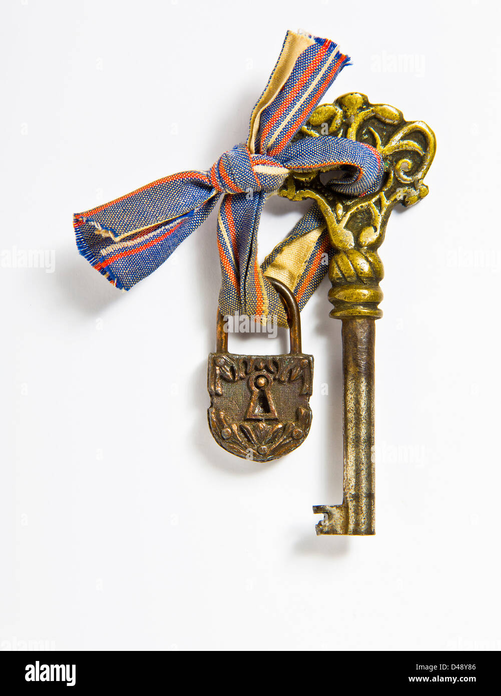 Little old lock and key on white background Stock Photo - Alamy