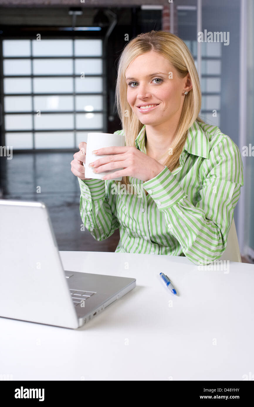Business woman at her desk in a modern office Stock Photo - Alamy