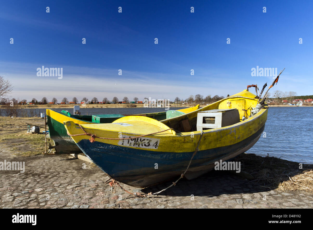 Yellow and blue colored , small fishing boats in small harbor near ...