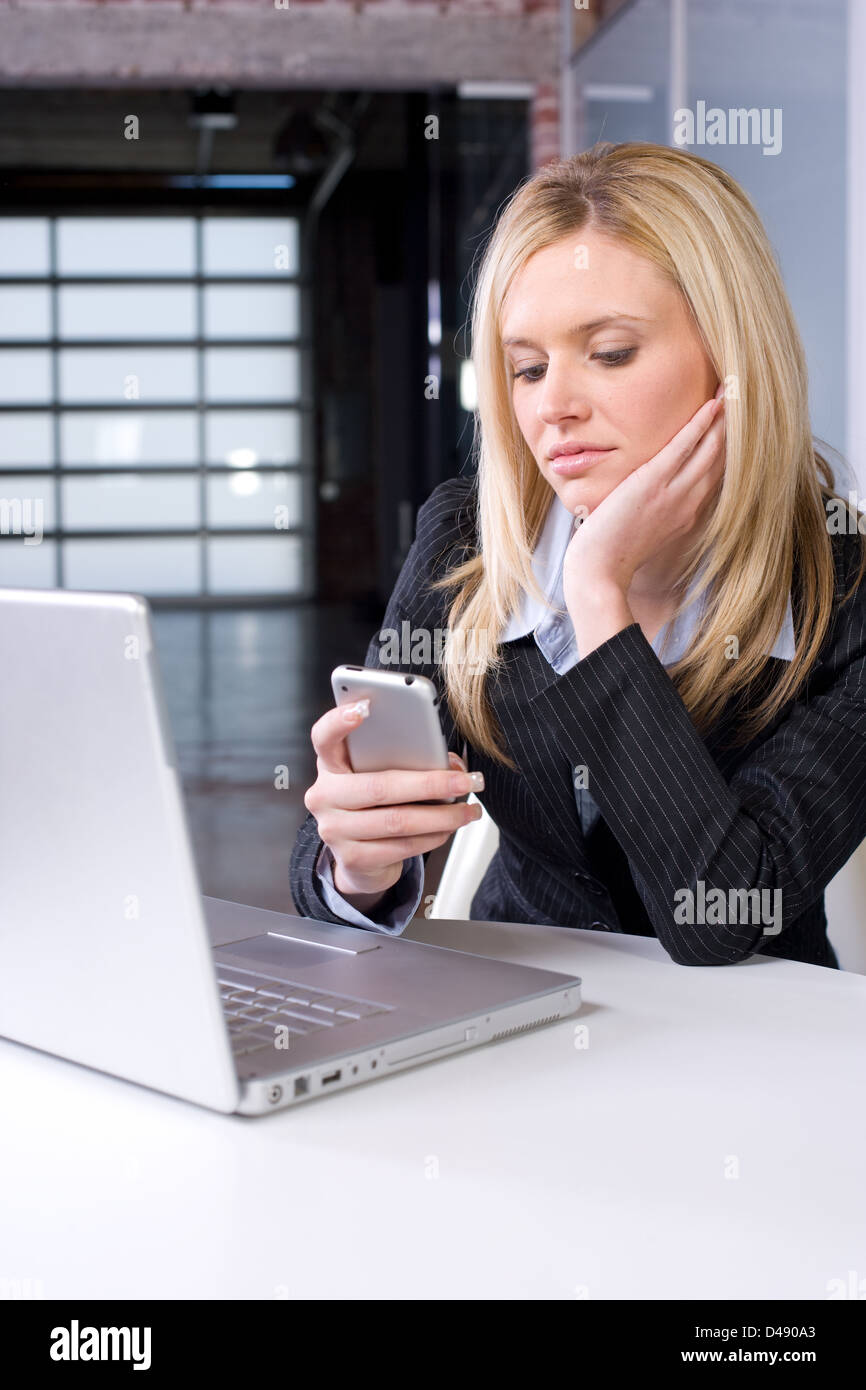 Business Woman on cell at desk in modern office Stock Photo - Alamy