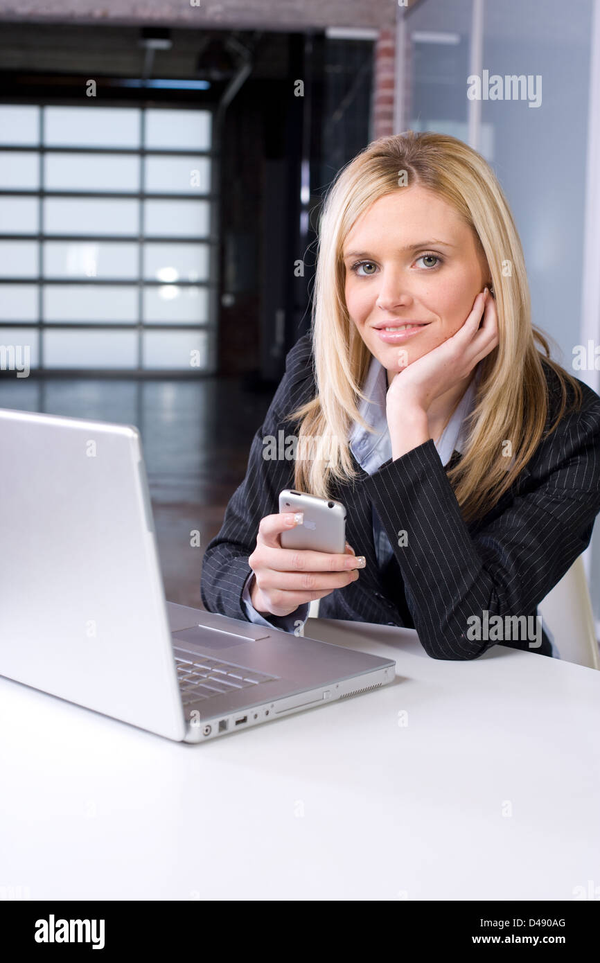 Business Woman on cell at desk in modern office Stock Photo - Alamy