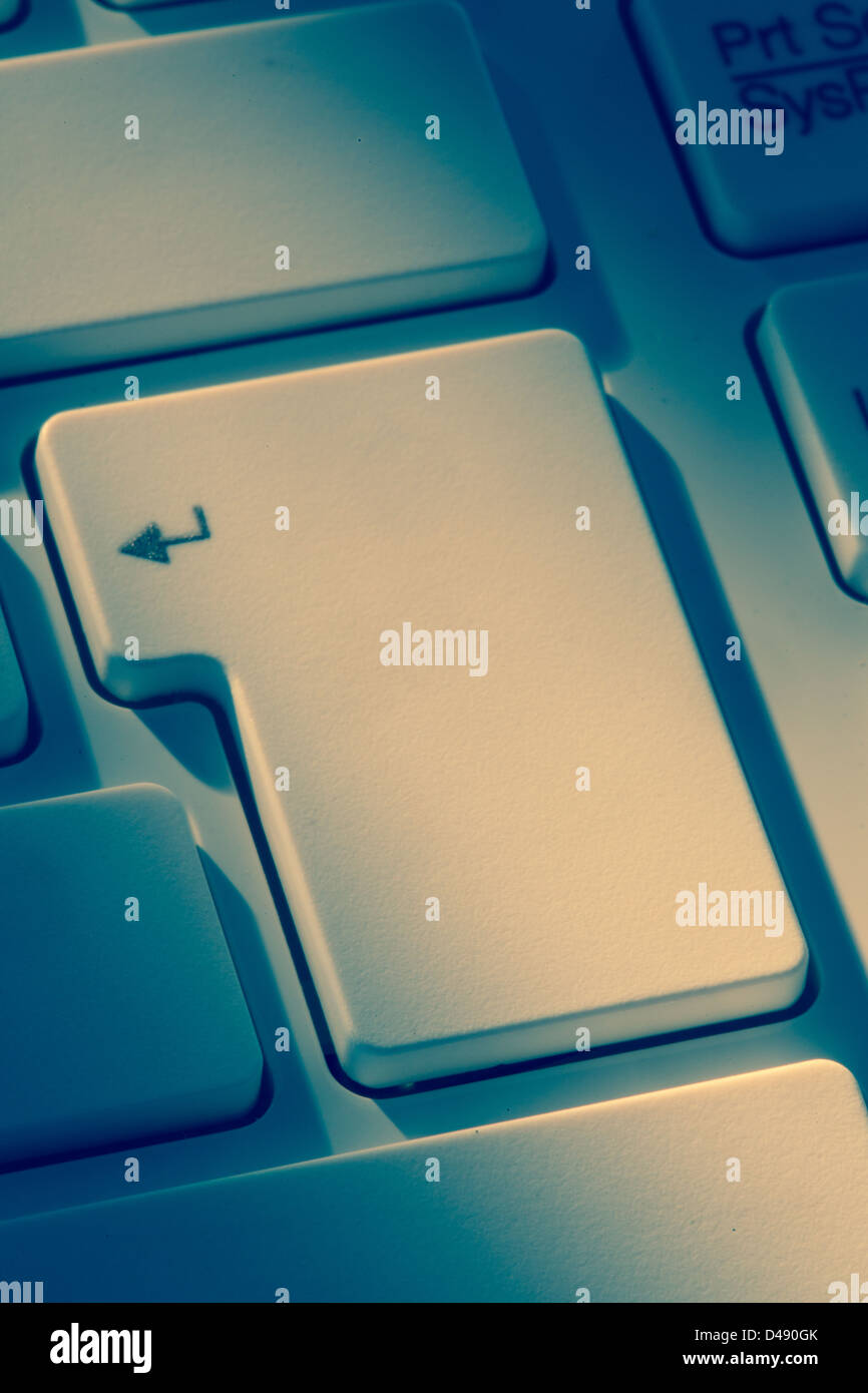 Enter key in close up in blue Stock Photo - Alamy