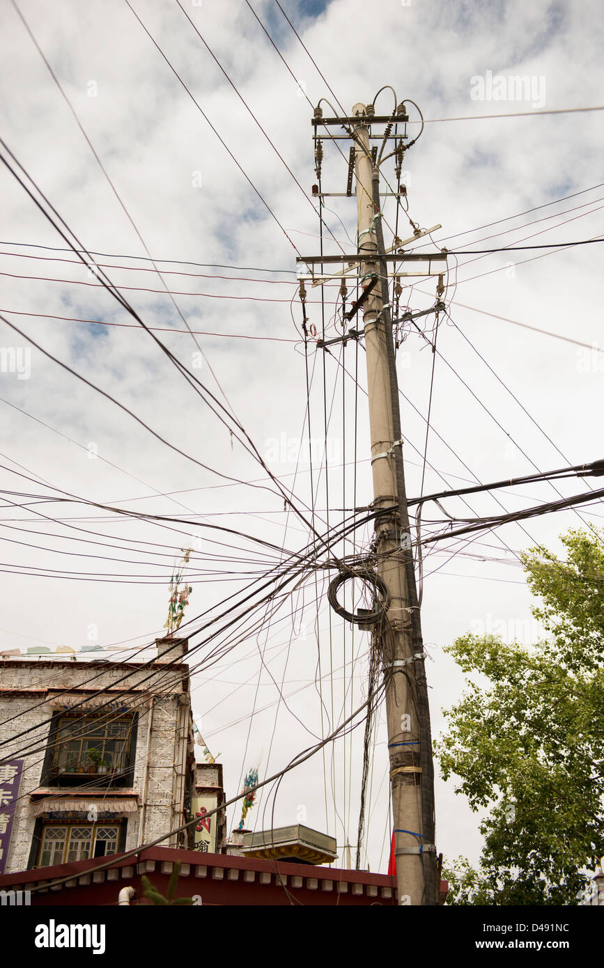 Pole overloaded with power lines;Lhana xizang china Stock Photo - Alamy