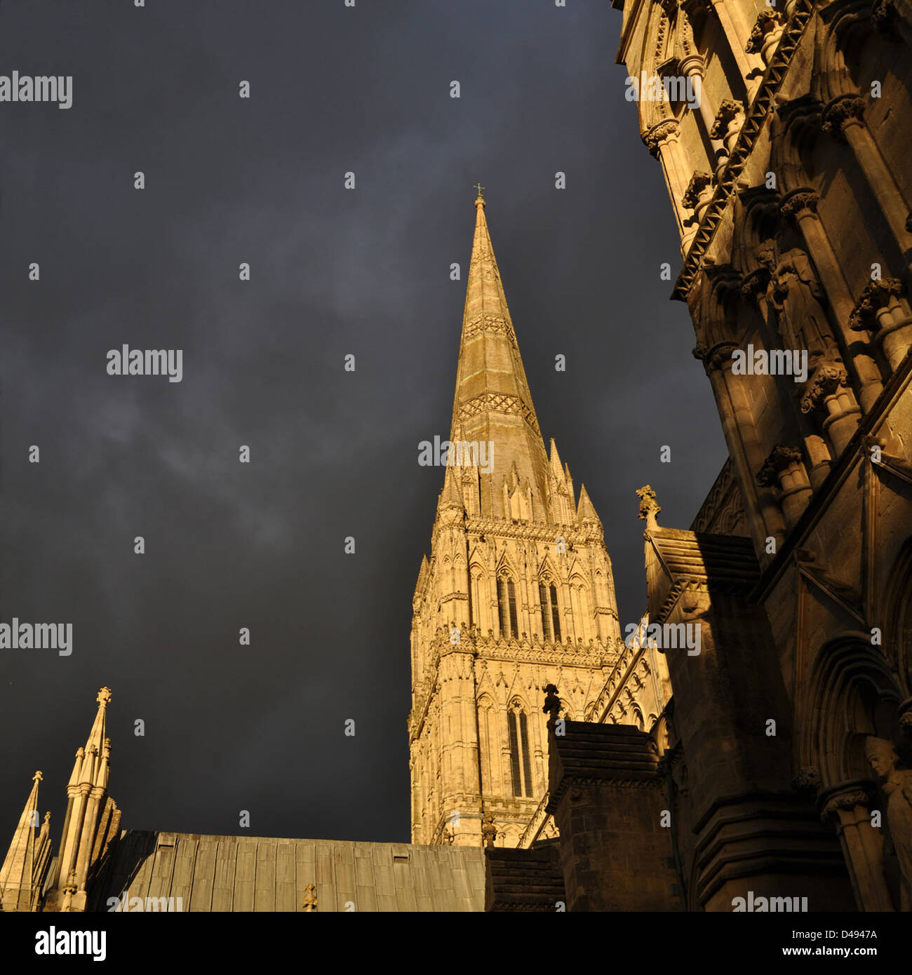 The spire of Salisbury Cathedral, captured under dramatic thunderclouds ...