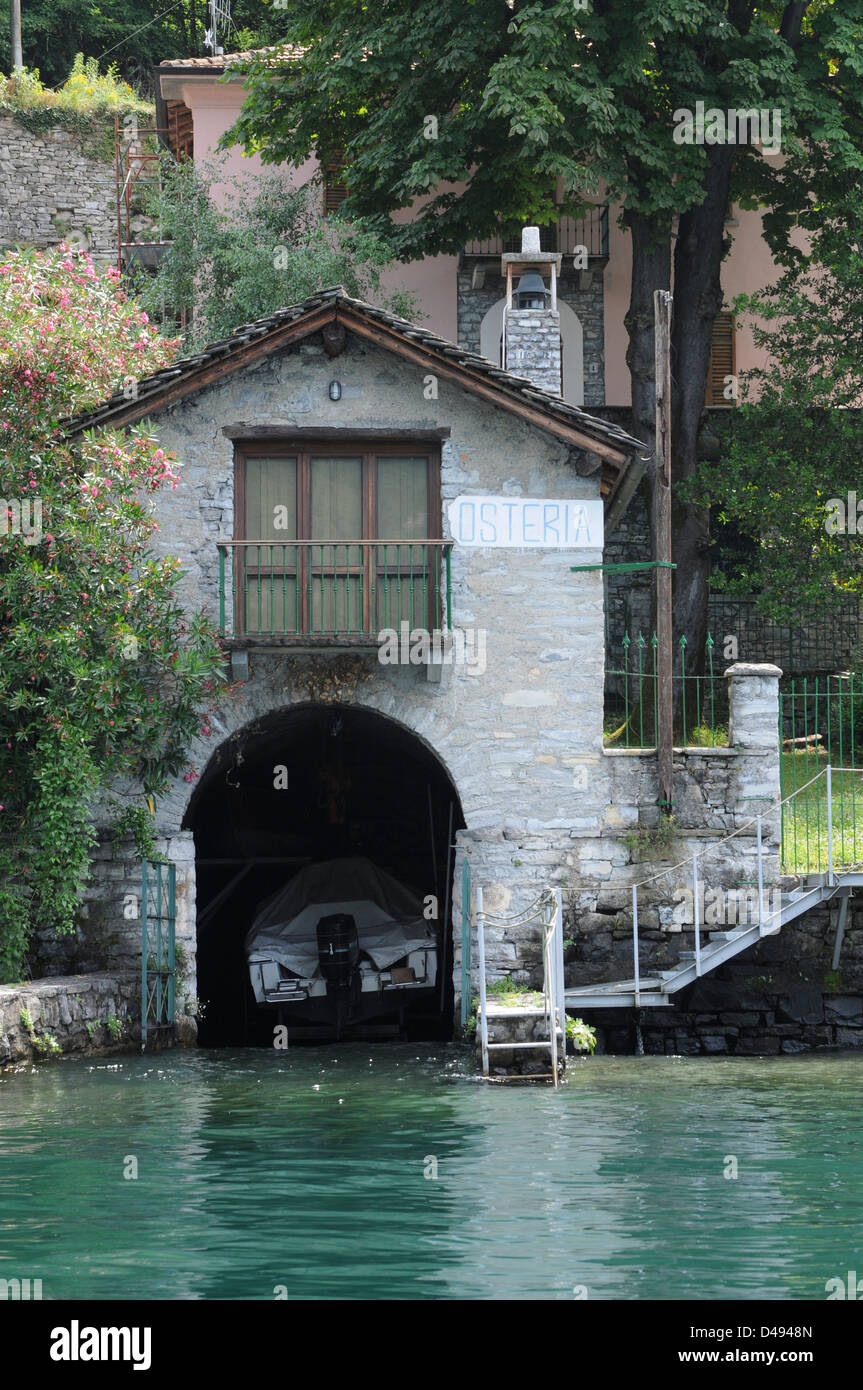 Italian Lakes, Lake Como,Italy July 2009. Boat house nestles on the ...