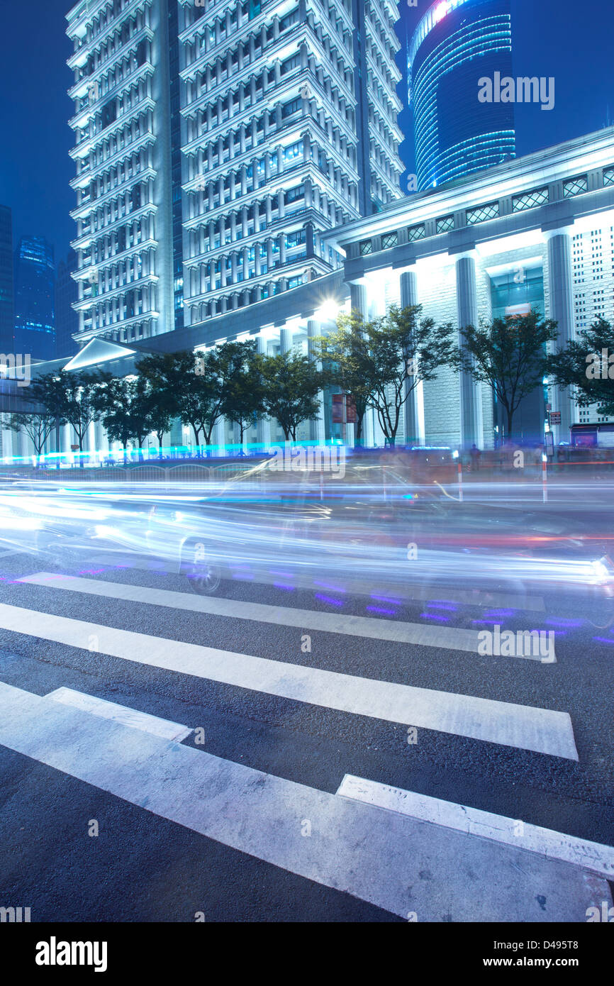 zebra lines in front business office building of night Shanghai city ...