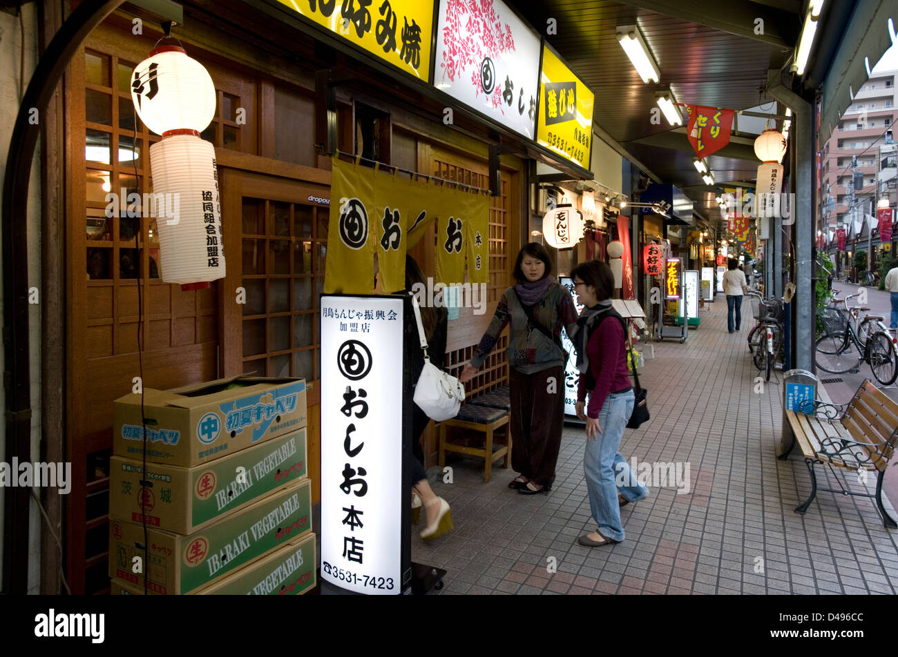 Patrons entering a manjayaki restaurant, where one can enjoy Japanese ...