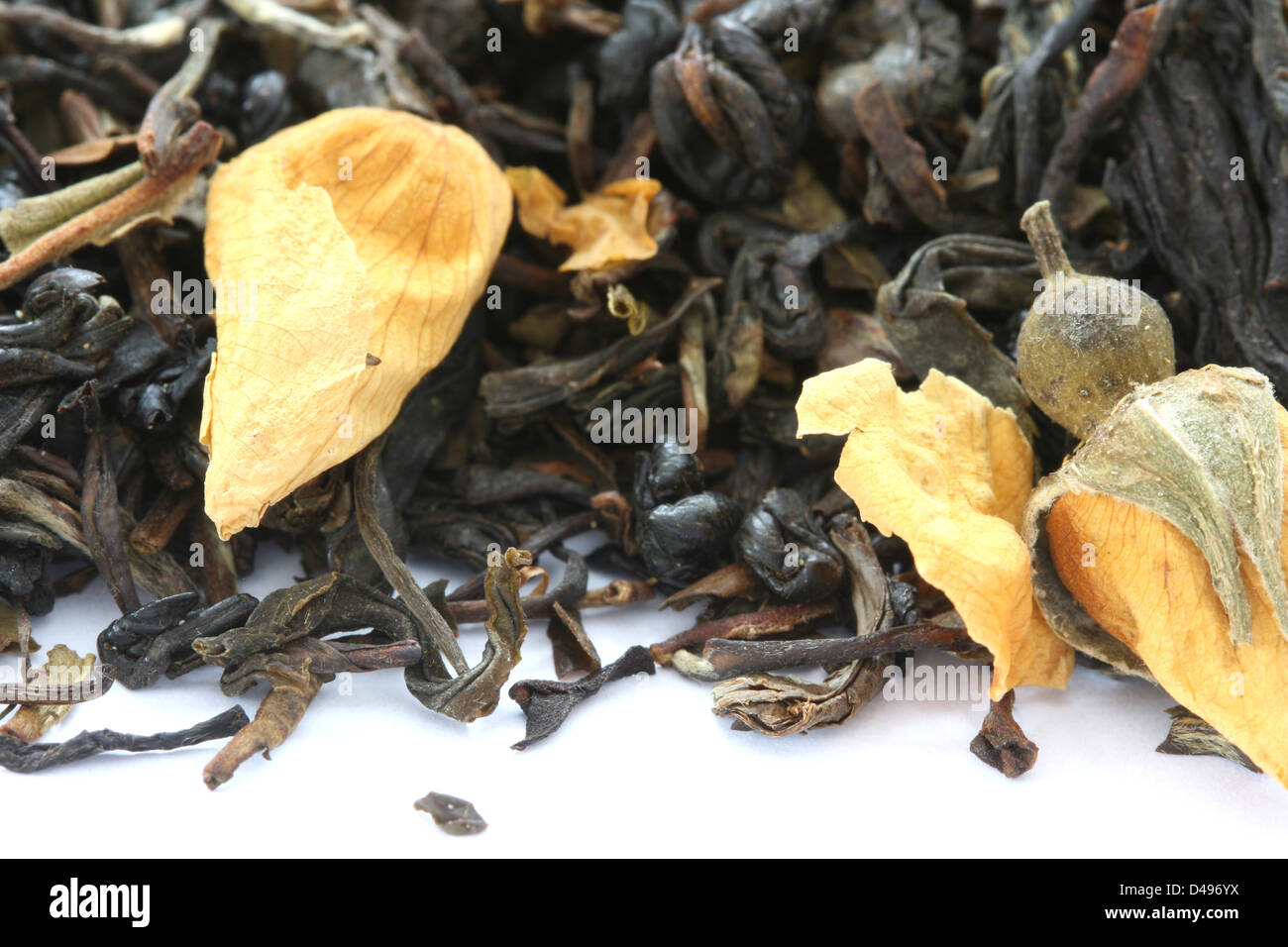 Dry black tea flavored with dry flower buds on white background Stock ...