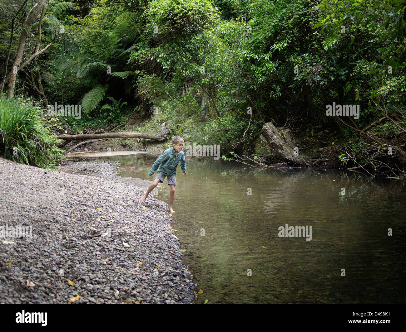 Stream river boy child wading paddling forest woods woodland water hi ...