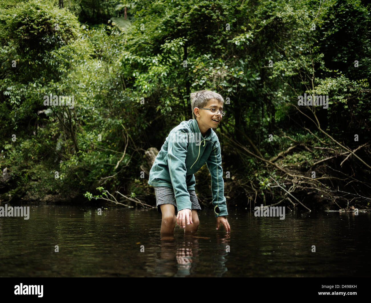Stream river boy child wading paddling forest woods woodland water hi ...