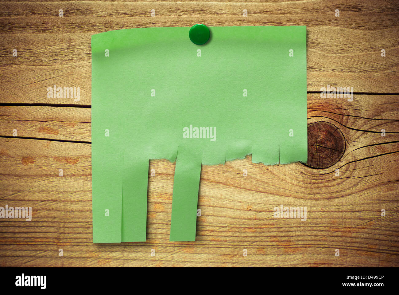 blank green note with tearable strips over wooden background, can be ...