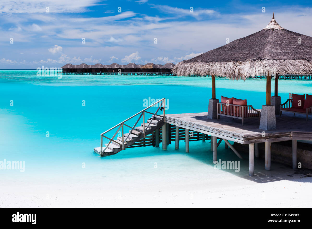 Over water jetty with steps into tropical blue lagoon Stock Photo - Alamy