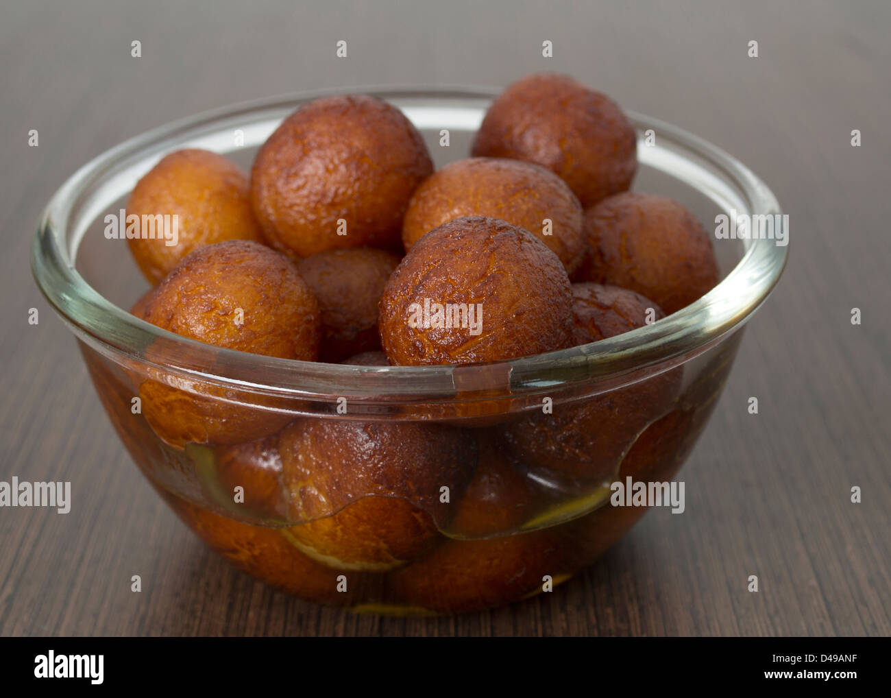 Brown sweet balls delicacy known as Gulab Jamun fried and served in a ...