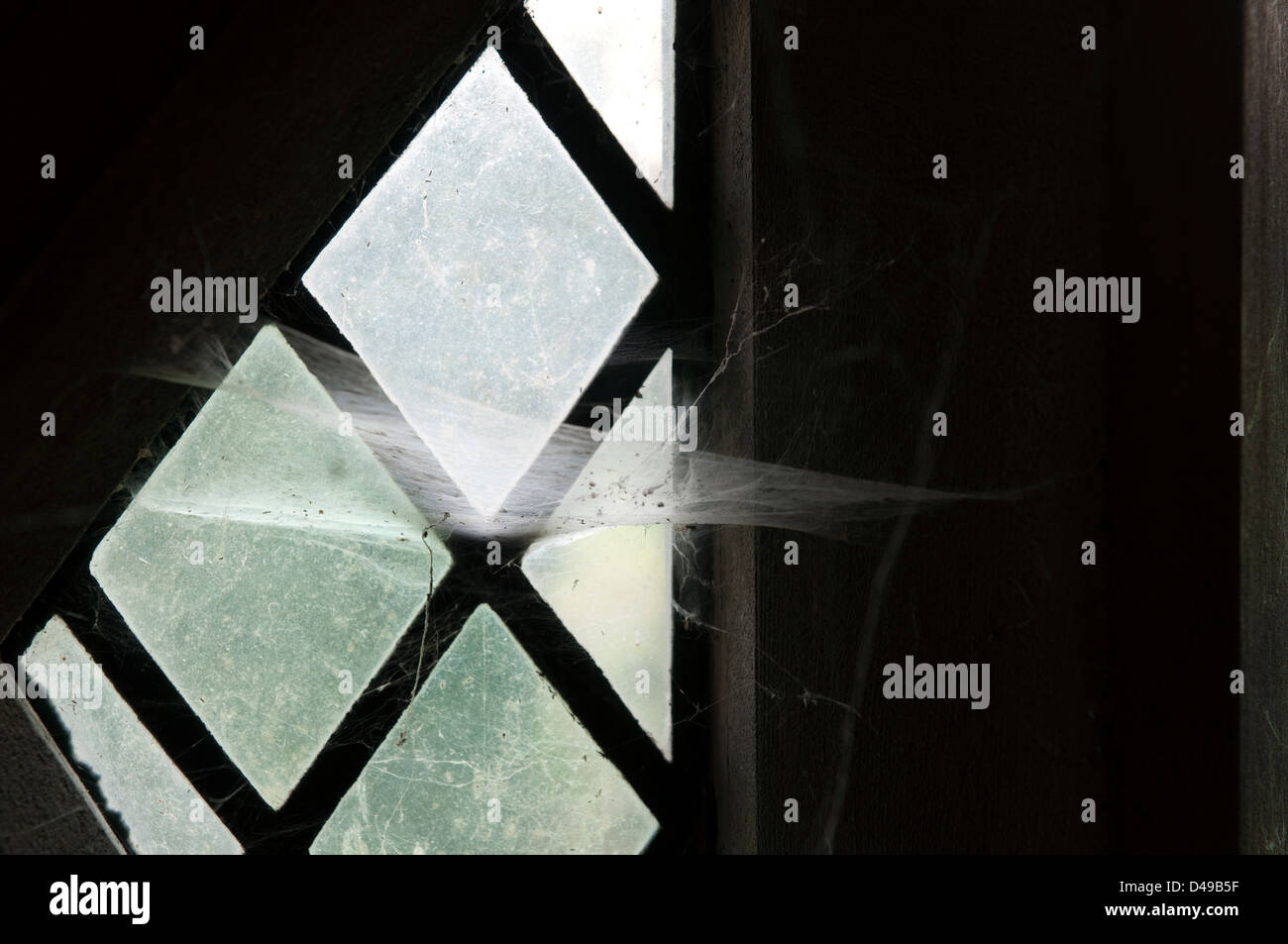 Cobwebs in a church window Stock Photo - Alamy
