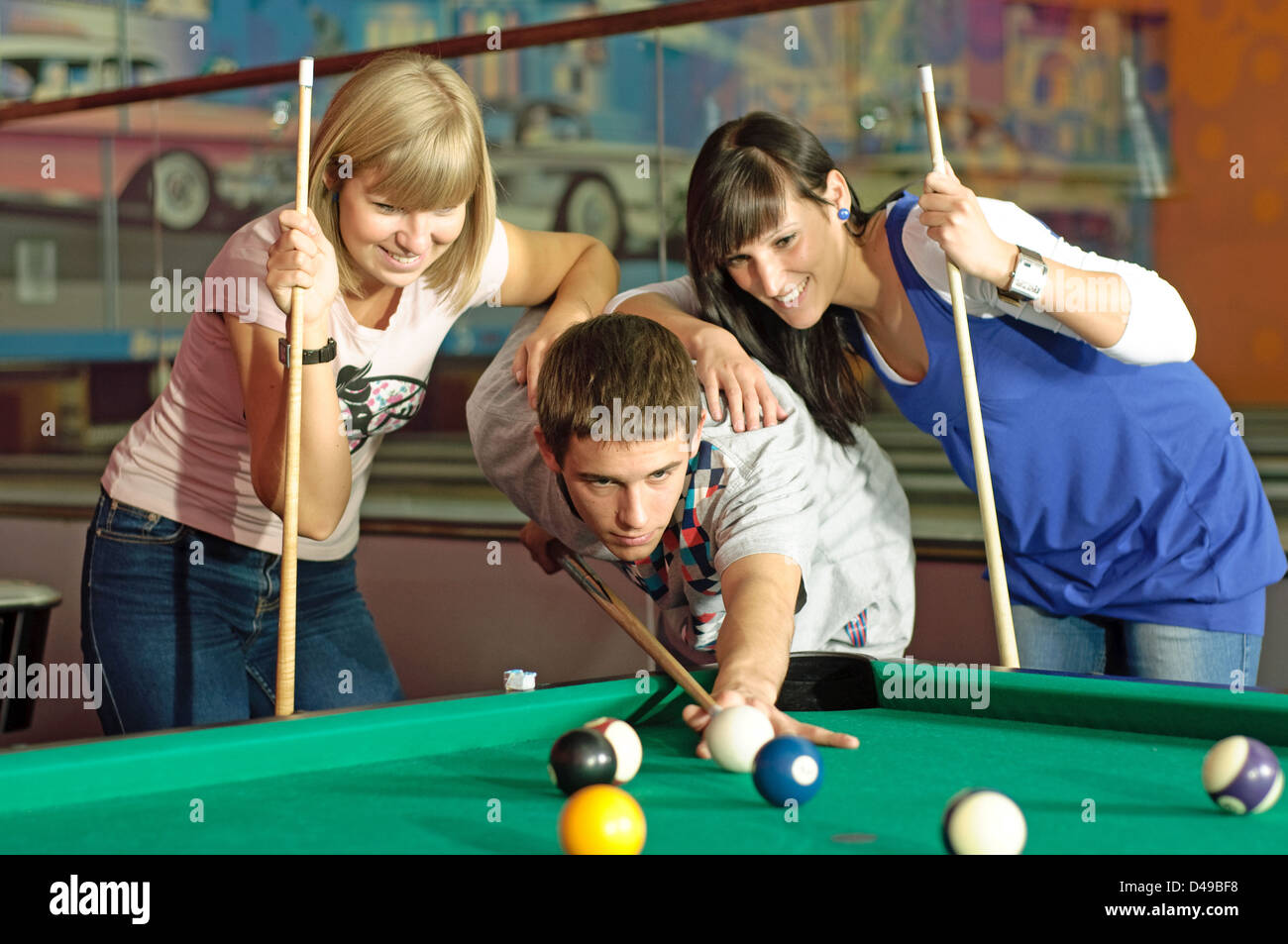 Photo of friends playing pool Stock Photo - Alamy