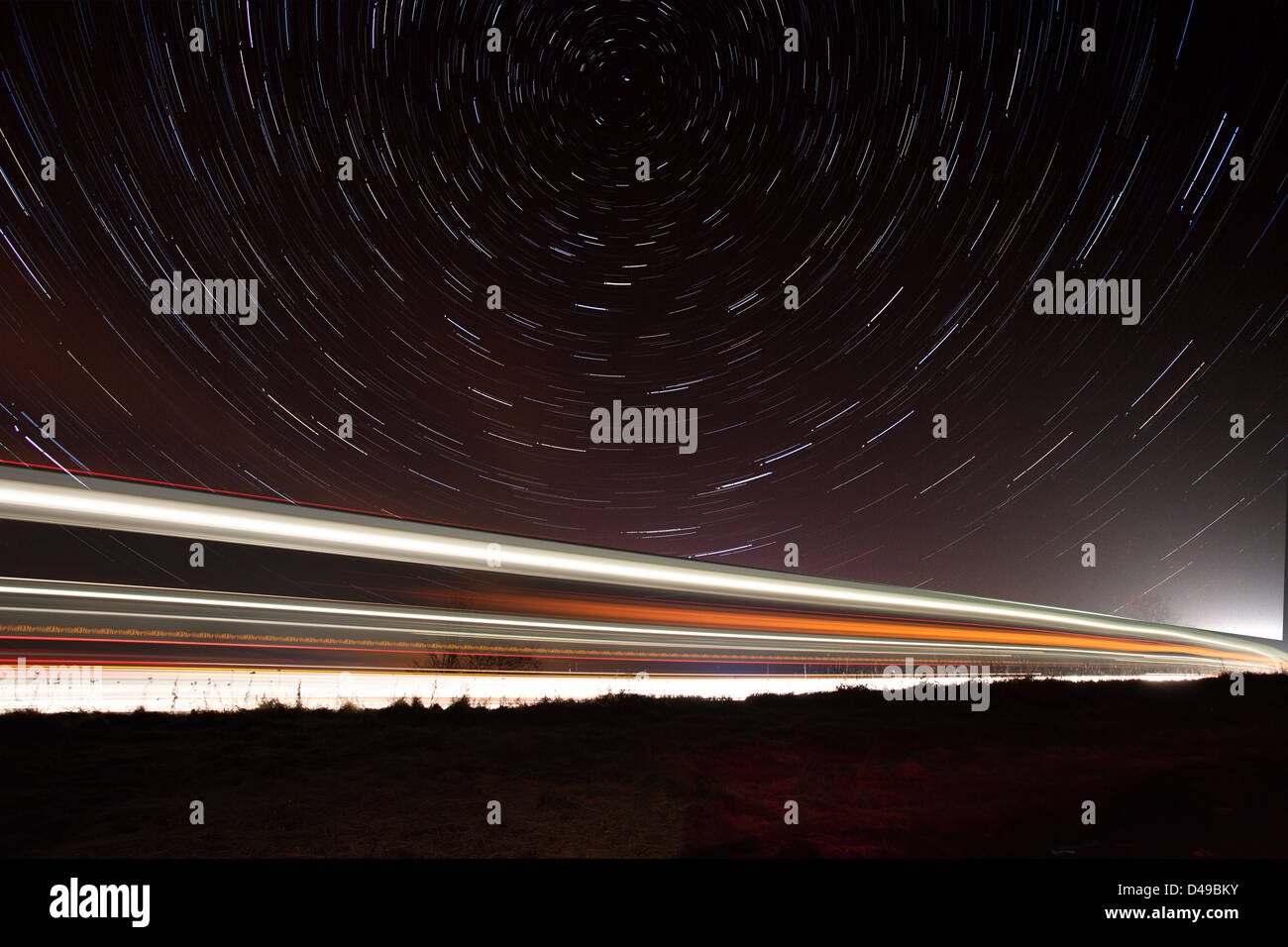 star trails with passing traffic making light trails Stock Photo - Alamy