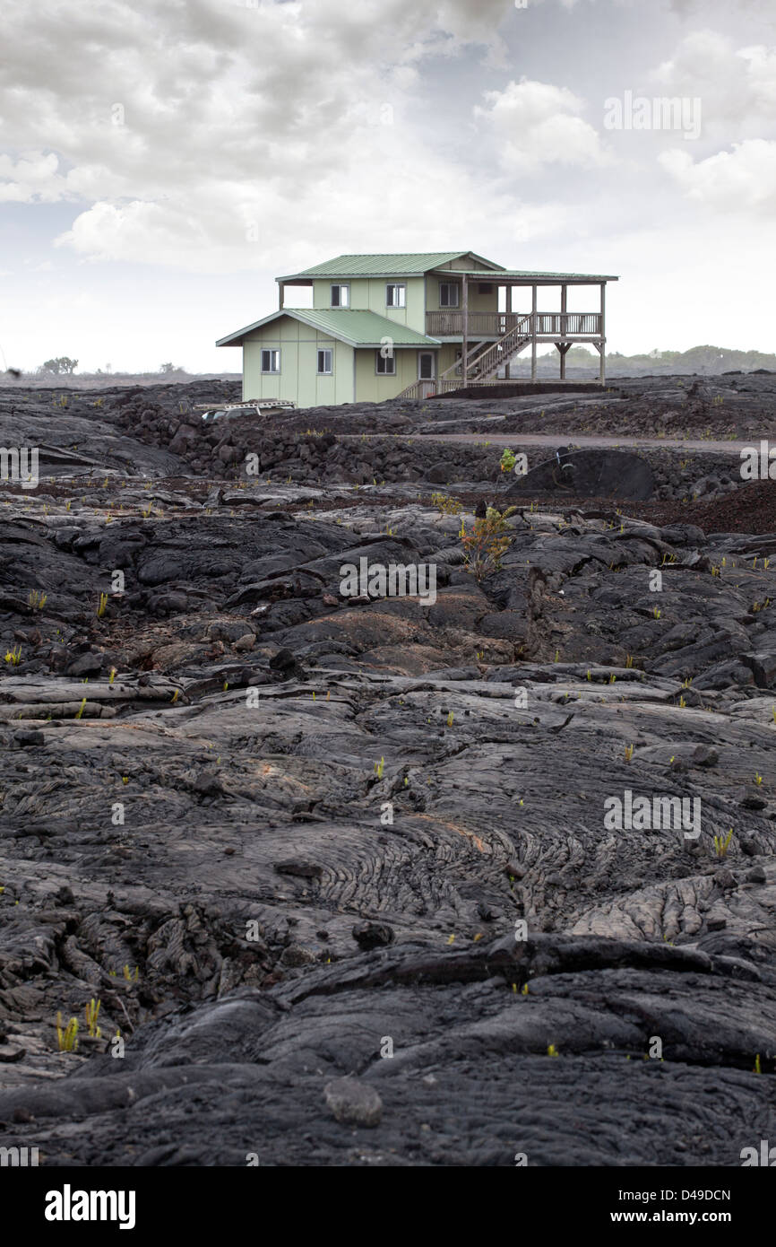 Lava formation with a house in the background at volcanoes national ...