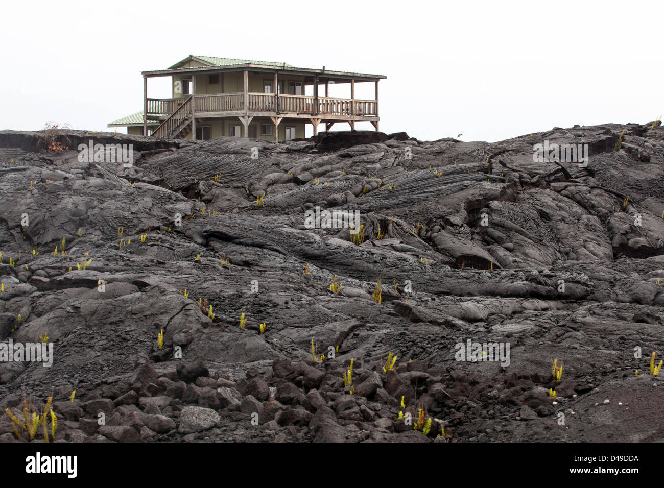 Lava formation with a house in the background at volcanoes national ...