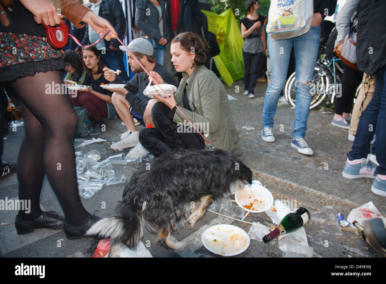 Berlin, Germany, a dog eats the remains of the visitors on the Myfest ...