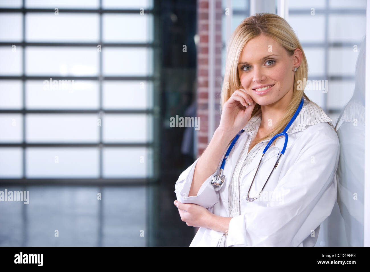 Young female doctor standing in a modern office Stock Photo - Alamy