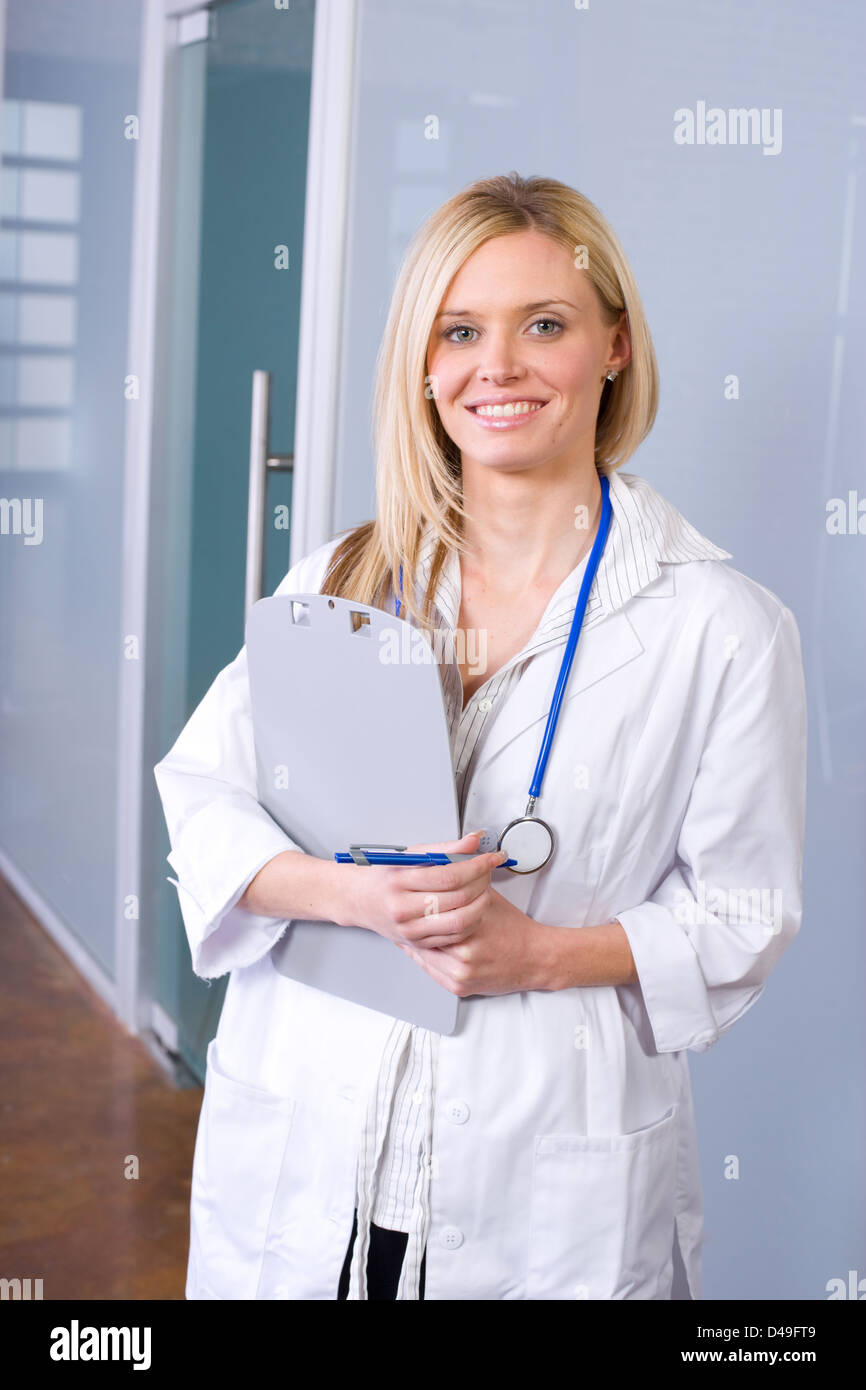 Woman doctor holding a chart in a modern office Stock Photo - Alamy