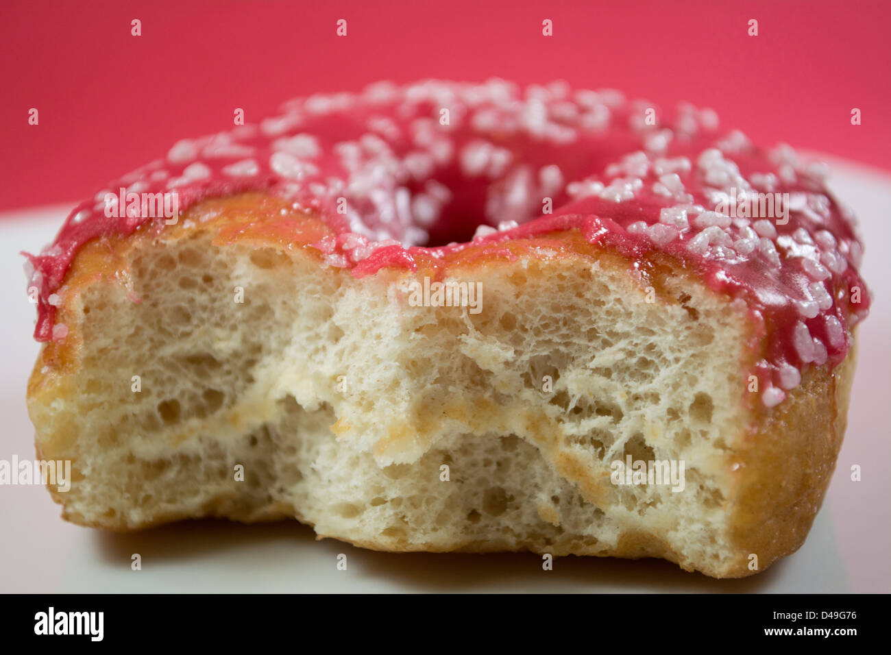 A horizontal image of a single doughnut, donut, with a bite out of it ...