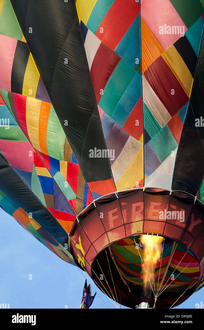 A jet of fire from the propane blaster heats the air inside a colorful ...